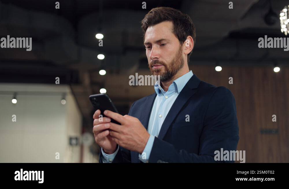 Officially dressed businessman sending message using personal ...