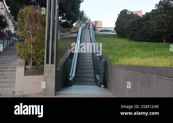 Barcelona, Catalonia - Spain - 01-07-2025: An outdoor escalator with ...