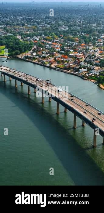Large beautiful bridge over the sea-green water. Vast sunny cityscape ...