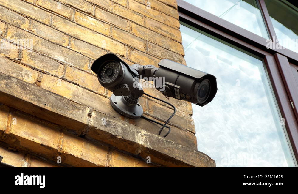 Monitoring the premises: BLACK CCTV camera installed on mall's wall ...