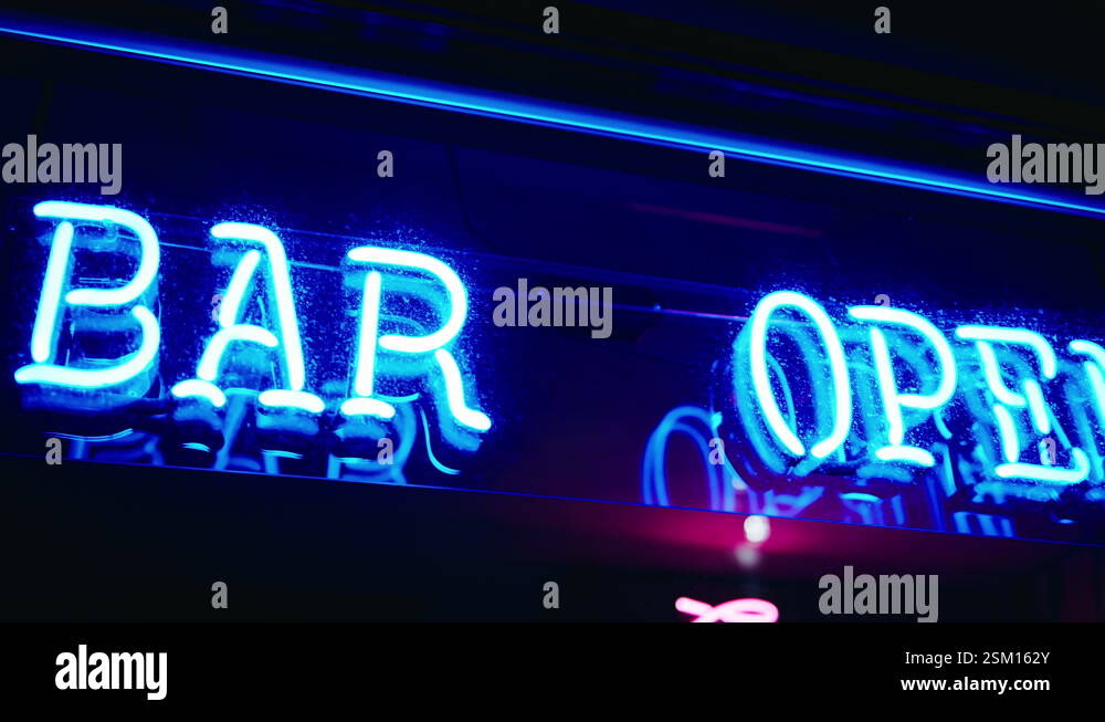 Illuminated BAR OPEN neon sign in vivid blue against the night sky ...