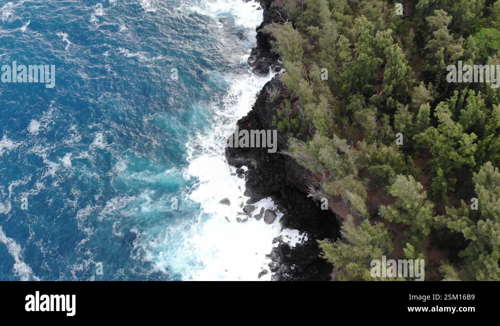 Flying over Mackenzie state park coastline in Hawaii with pacific waves ...