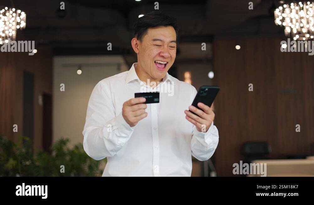 Happy businessman making online payment with credit card on personal ...
