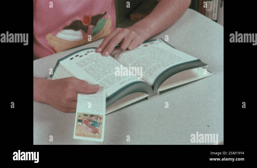 1970s: animation of smoke and torn corner of page in book, hands put ...