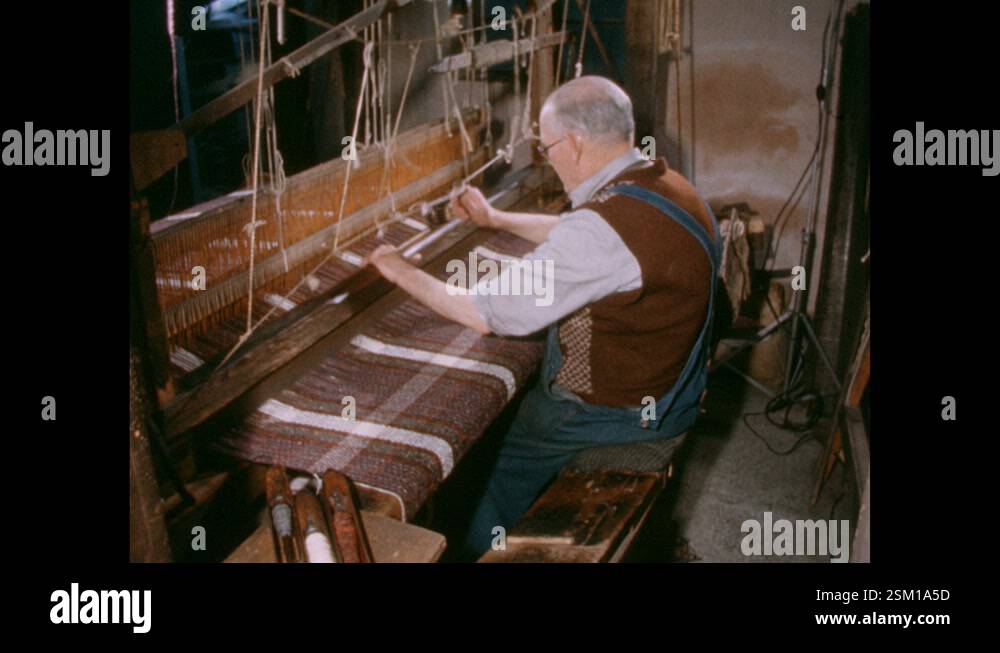 1960s: Seated man working large loom, weaving tartan fabric Stock Video ...