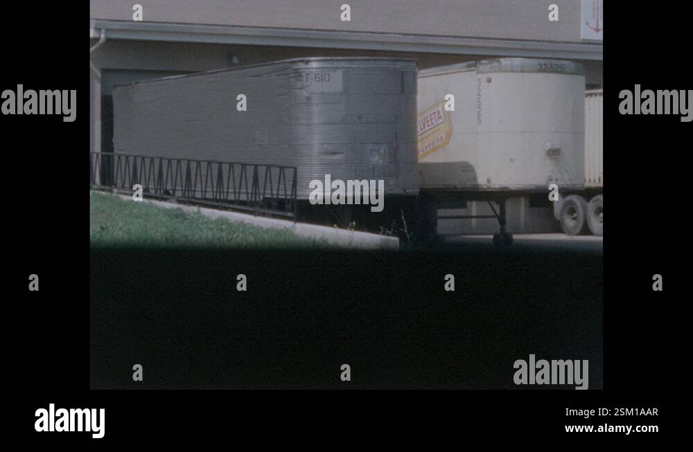 1960s: Large storage tanks in parking lot, one with wheels Stock Video ...
