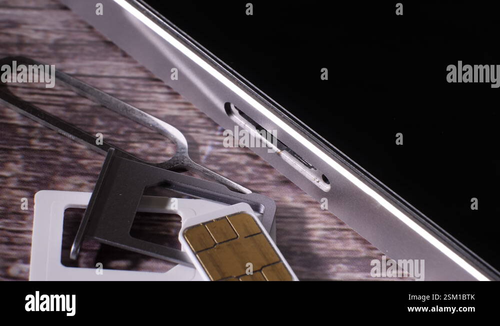 Closeup shot of the sim card slot of a silver colored smartphone ...