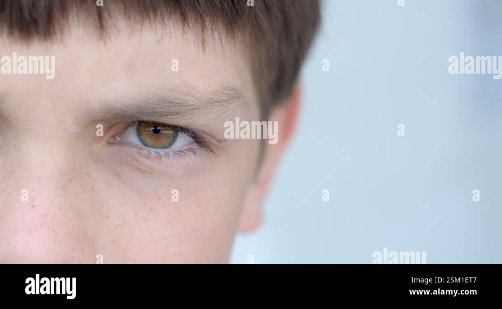close up portrait of teenage boy without smile, eyes as a part of face ...