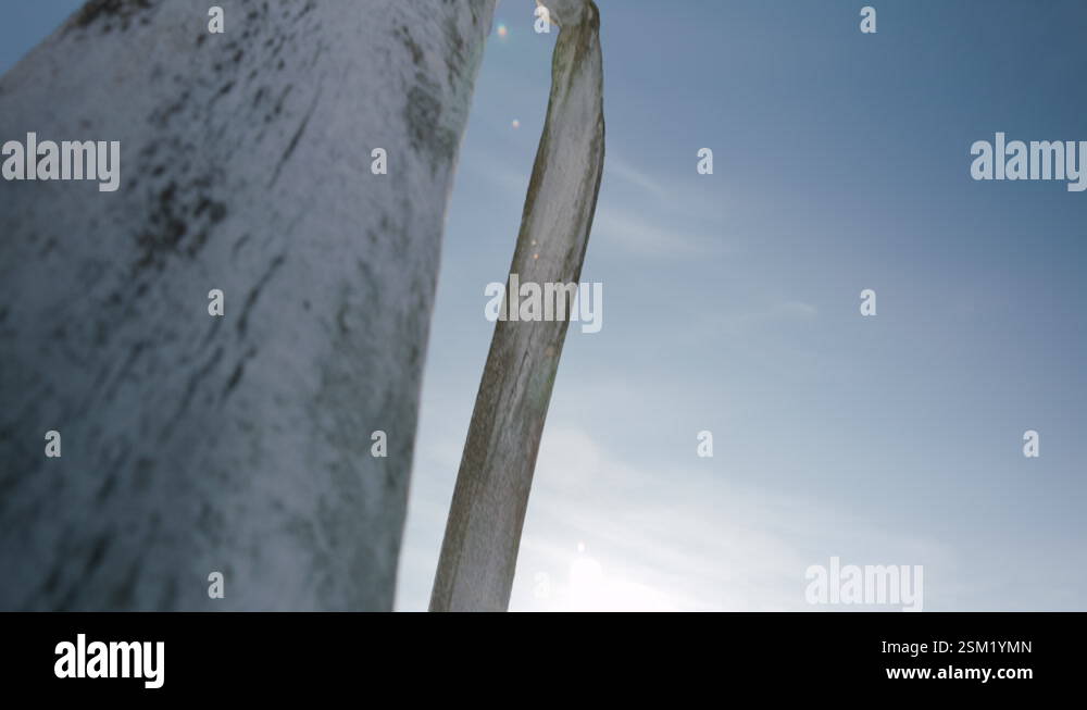 Tilt up from winterized boat to Whale Bones arch at Utqiagvik Barrow ...