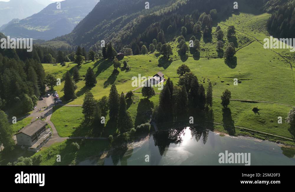 Sun reflection on a beautiful lake in summer swiss in a scenic drone ...