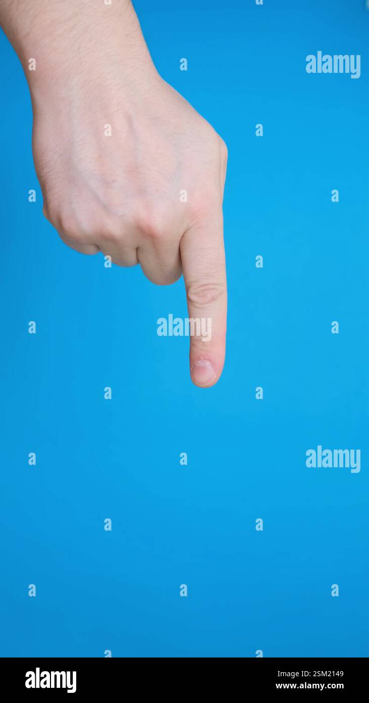 Male hand pointing a finger to the side, making a hand gesture ...