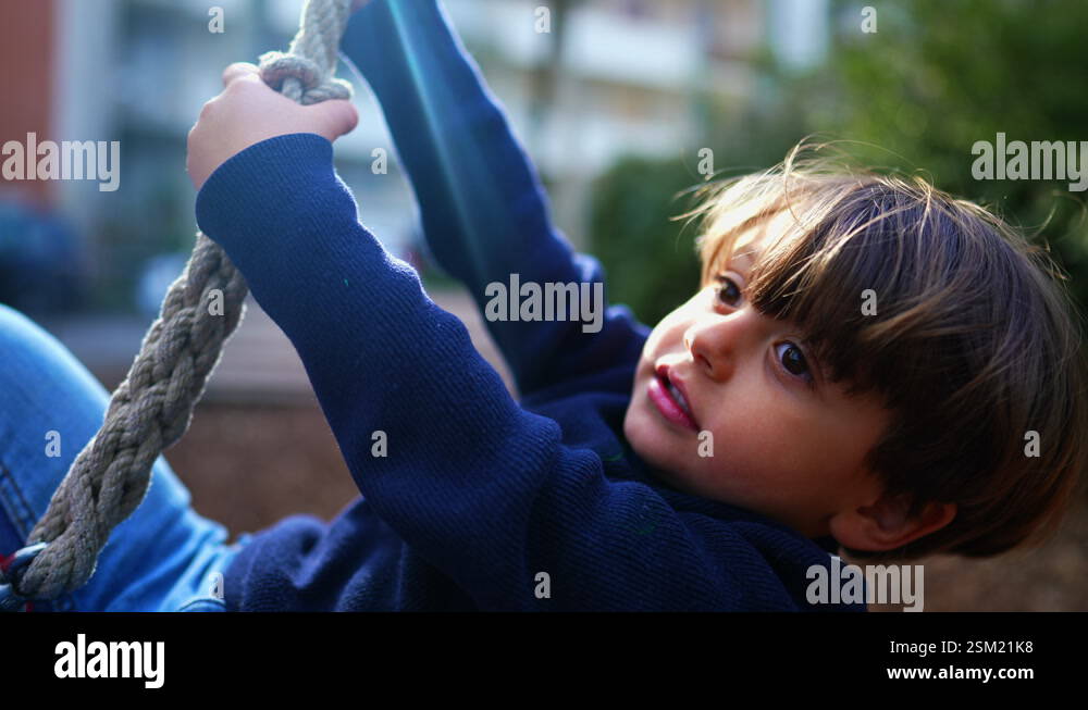 Child Holding Tight and Sliding to End of Wire Rope at Public Park ...