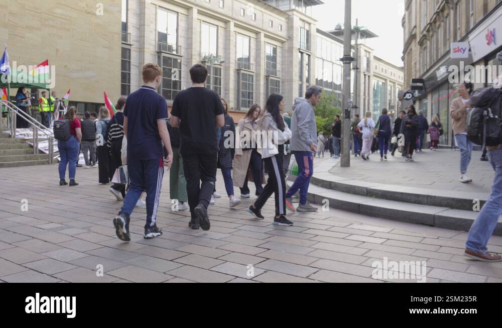 People of Glasgow walking past the scene of a group of protesters Stock ...