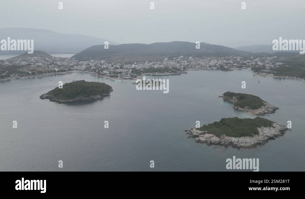 Drone shot flying over the water over the small islands in front of ...