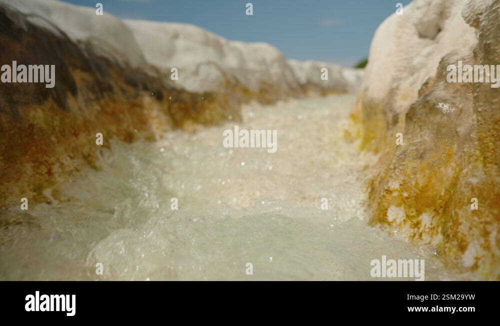 White Stone Gutter through which Water Flows from a Spring, with ...