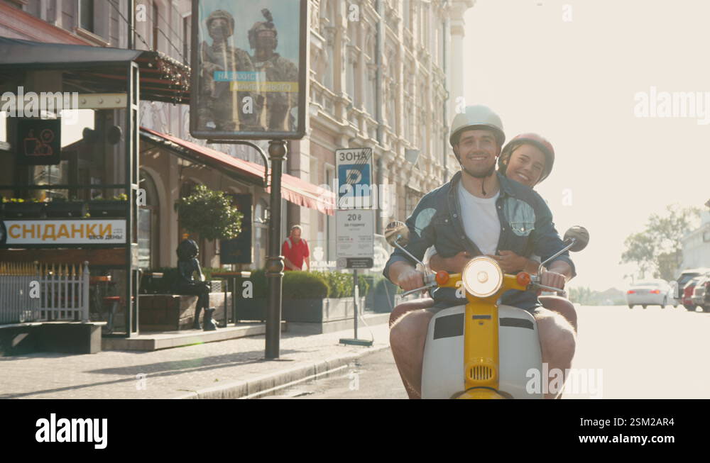 Man and woman ride motorcycle along streets of sunny city Stock Video ...