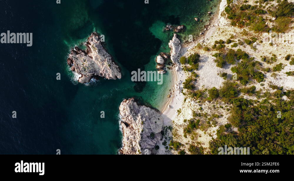 Bird's eye view top down static of rugged shoreline of Lubenice beach ...