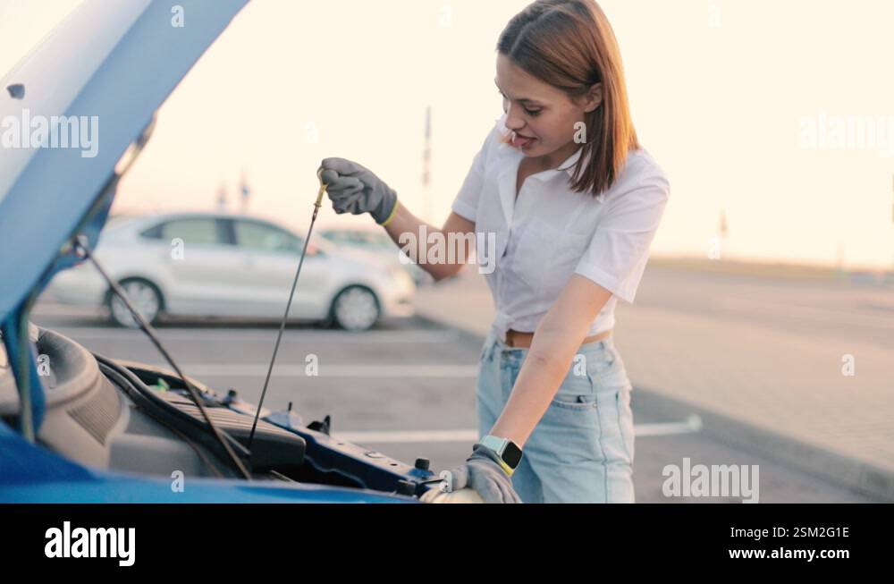 woman hood open was driving along the road checking the engine oil level Stock Video Footage - Alamy