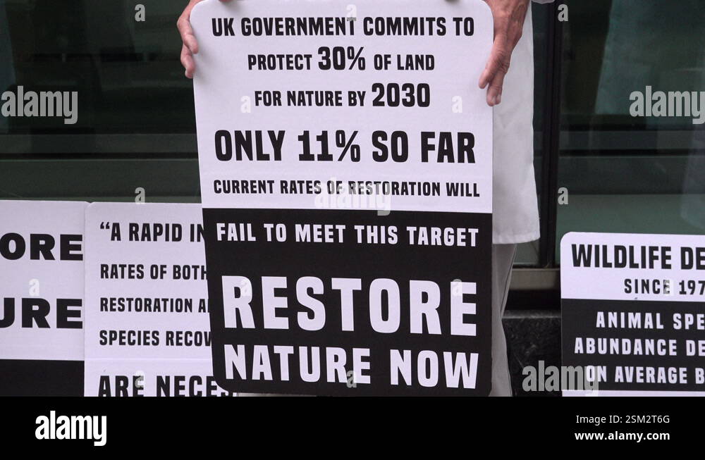 A protestor placard reads, “UK government commits to protect 30% of ...