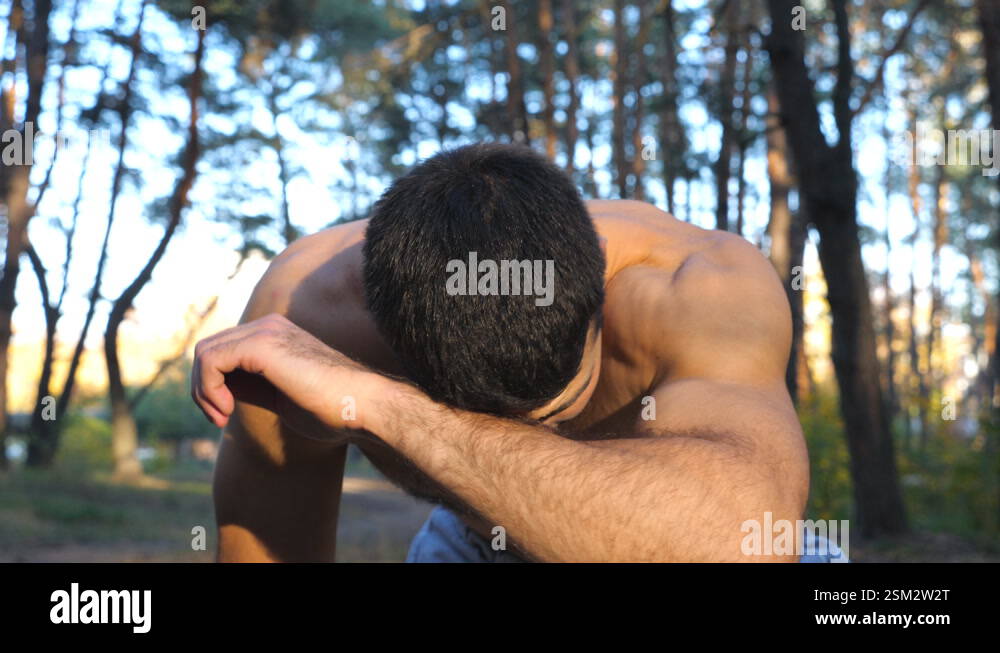 Portrait of tired guy taking break after hard run workout in forest ...