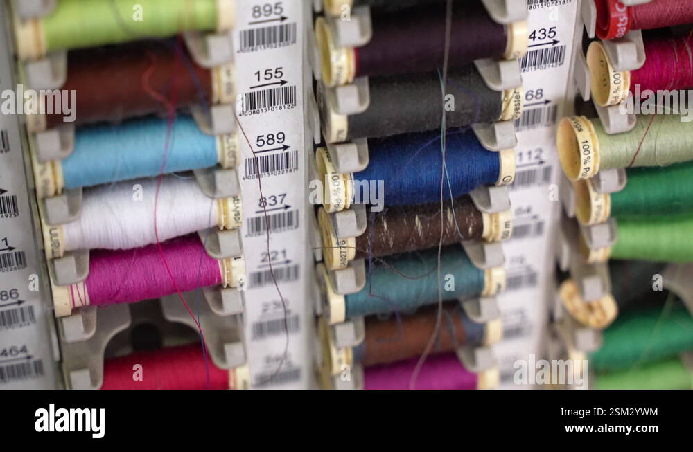 Reels of colourful cotton threads on special vertical board in tailor ...
