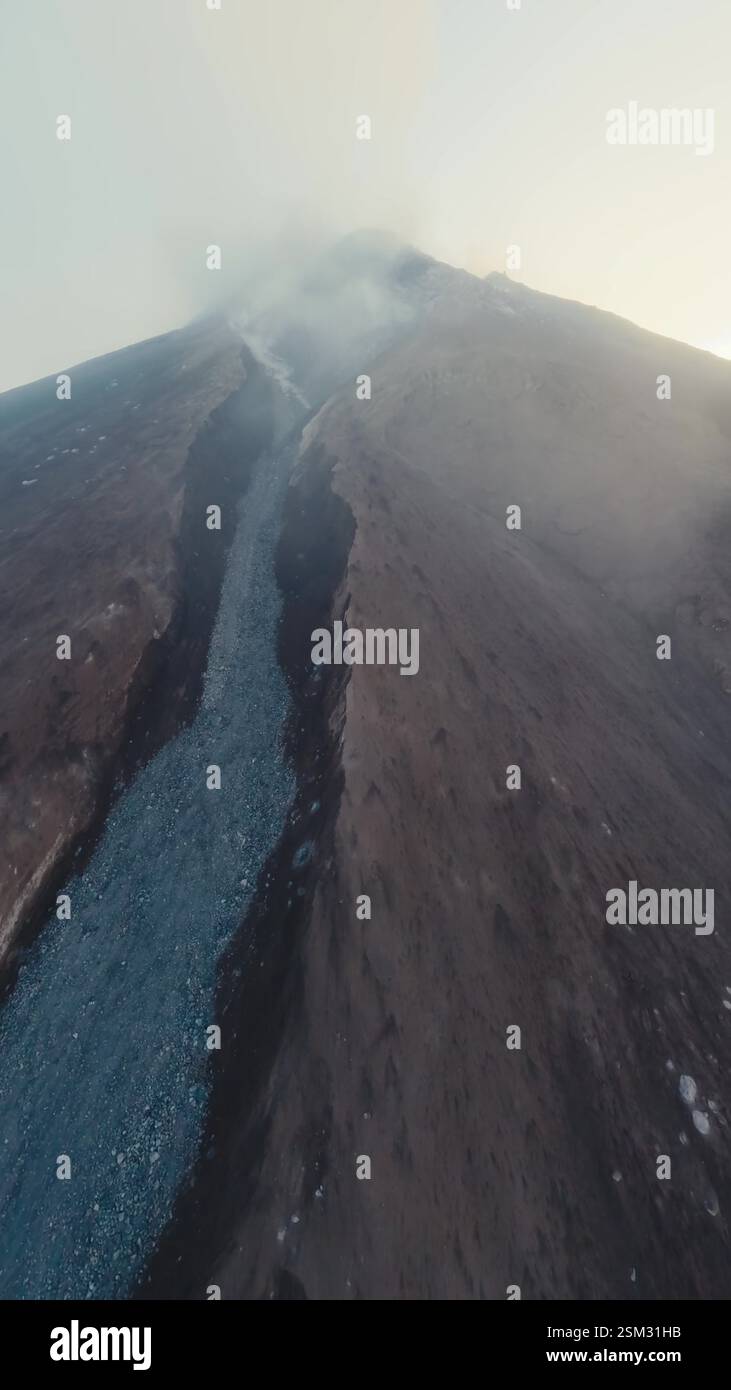 Vertical video. Aerial extreme view peak smoke crater active erupting ...
