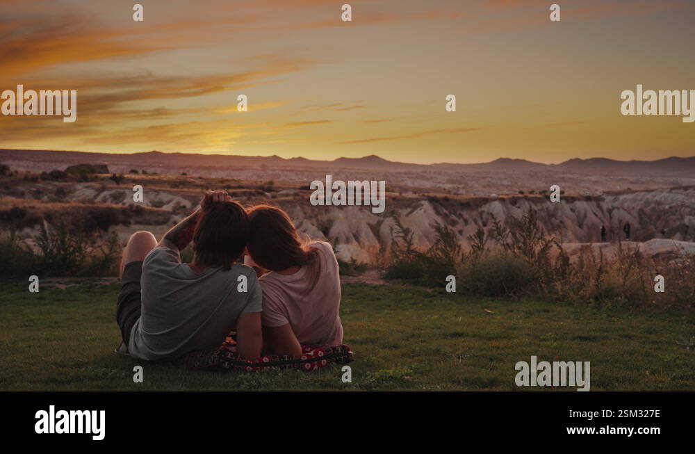 A loving couple, a man and a woman, lie on a cushion in the mountains and watch Stock Video ...