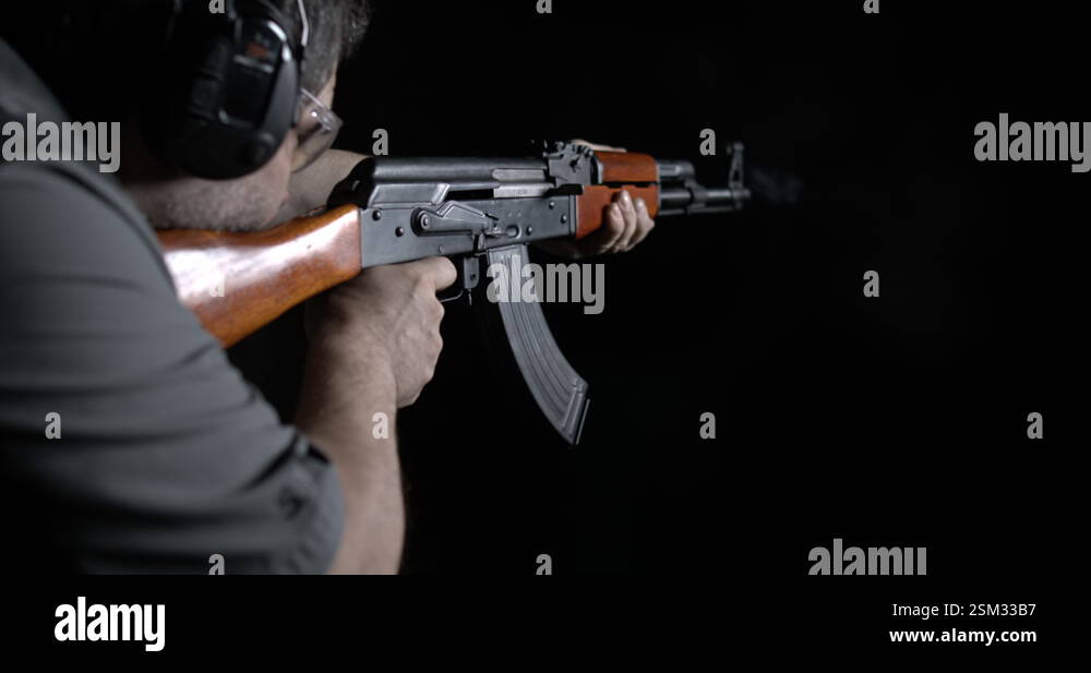 Shooting Kalashnikov weapon at highs-speed 800 fps slow-motion. Person ...