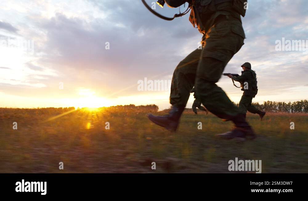 Squad of armed soldiers surround military enemy and run taking aim to ...
