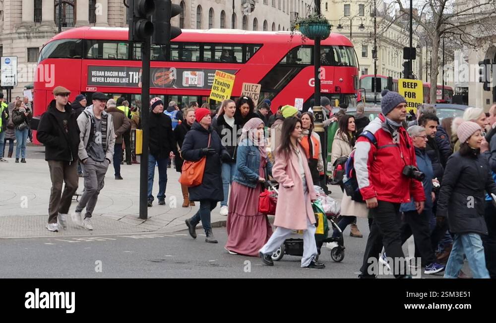 Multi-ethnic pedestrians crossing street on crosswalk in London city ...