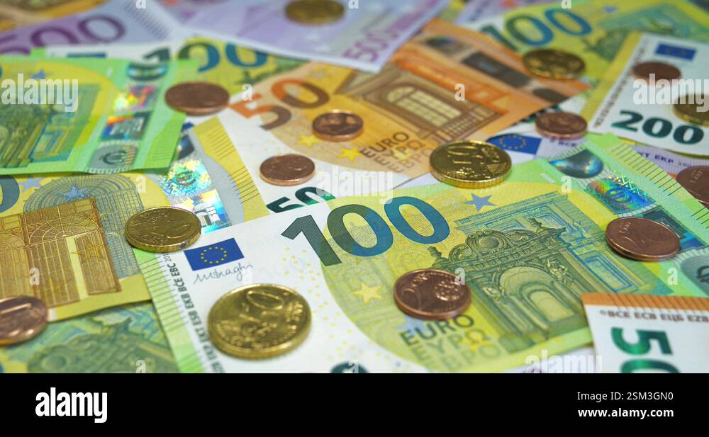 Real euro banknotes and metal coins of various colors, size and ...