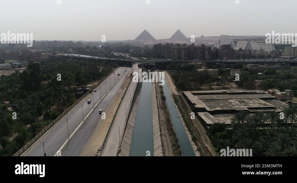 Aerial Shot for The Pyramids of Egypt in Giza beside a branch from the ...
