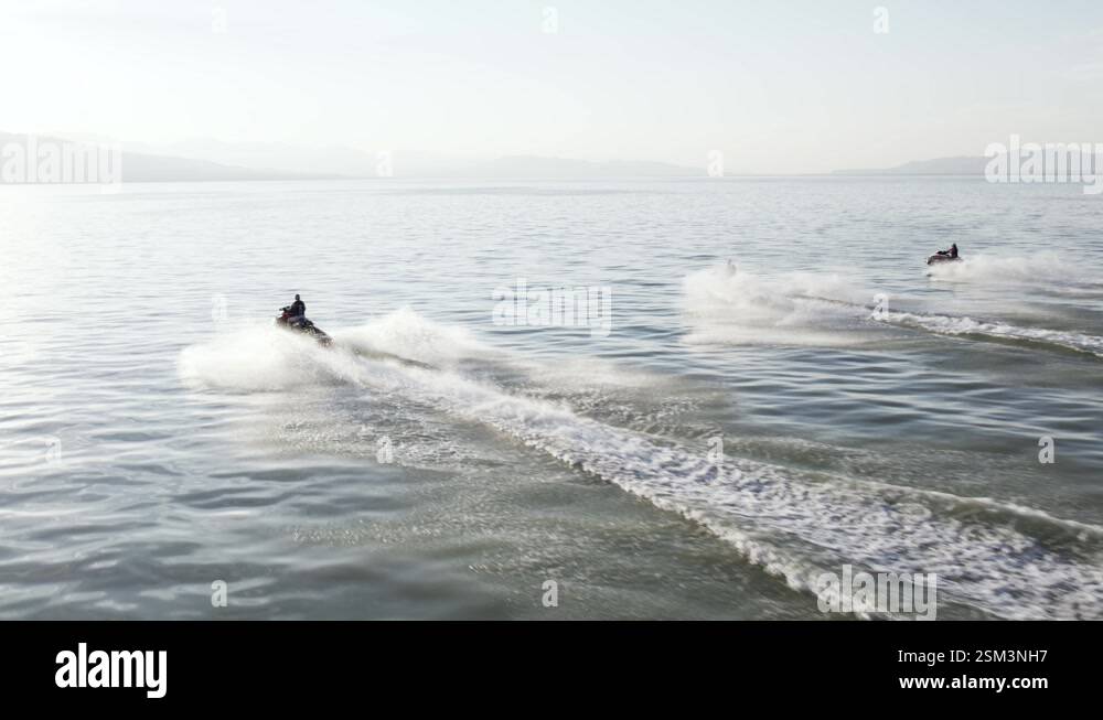 Three Riders Racing Jet Ski Waverunners on Utah lake, Aerial with Copy ...