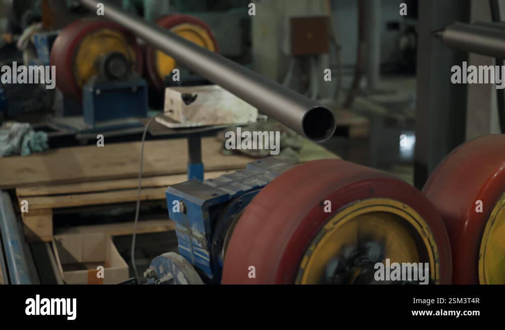 Pulling the steel tube through the rotating processing machine at the ...