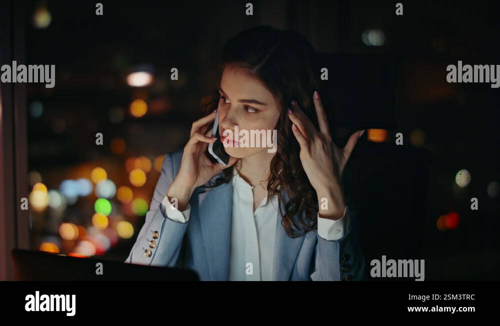 Worried business lady calling clients at workplace in night close up ...