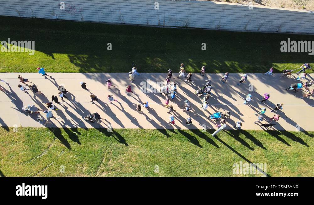 Runners take off from the starting line of a local 5k 10k charity run ...