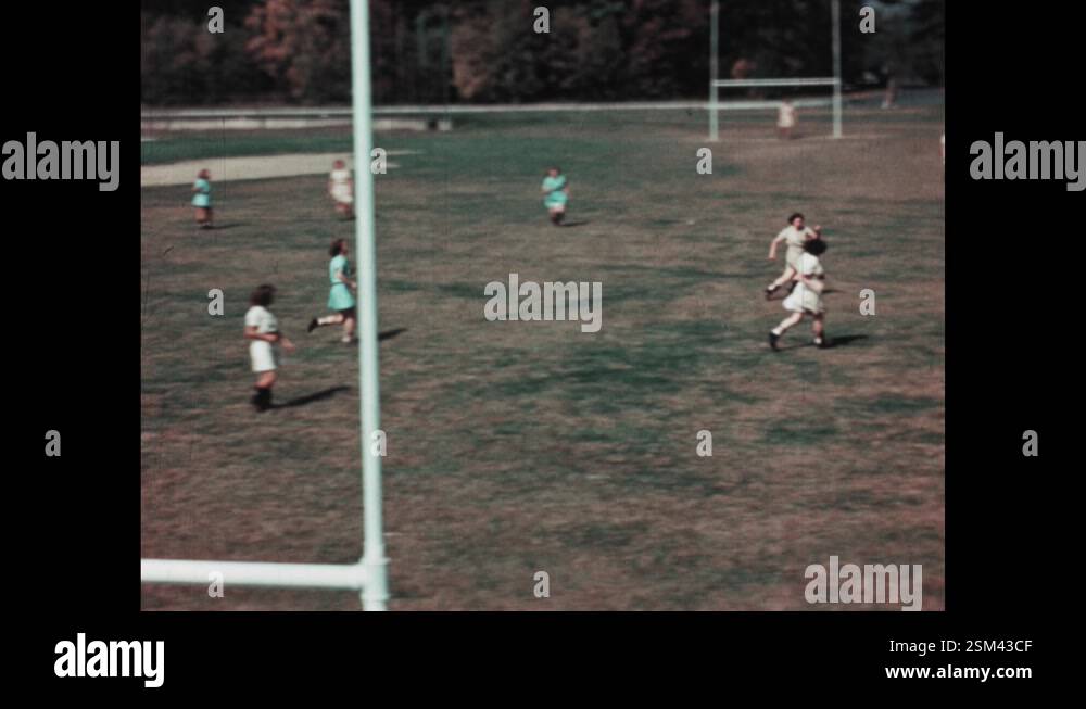 1950s: High angle panning shot, girls playing soccer. Girls cheering in ...