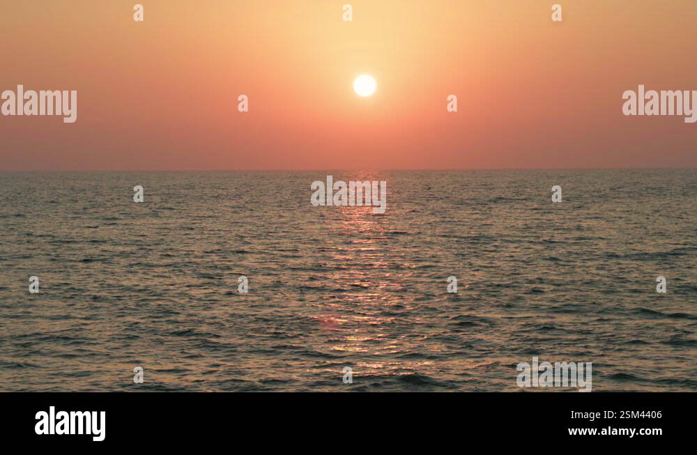 Red sunsets over sea video. The sun touches horizon. Red sky, yellow ...