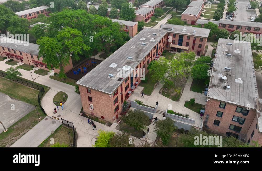 Cheap housing outside of city in suburb. People at apartment complex in ...