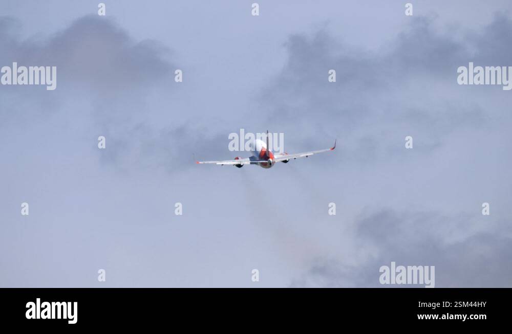 Rear View of Passenger Airplane Taking Off with Sky Background TRACK ...