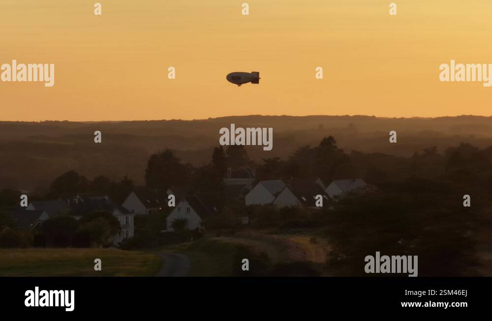 Unique ways to travel. Silhouette of a Zeppelin aircraft. Golden hour ...