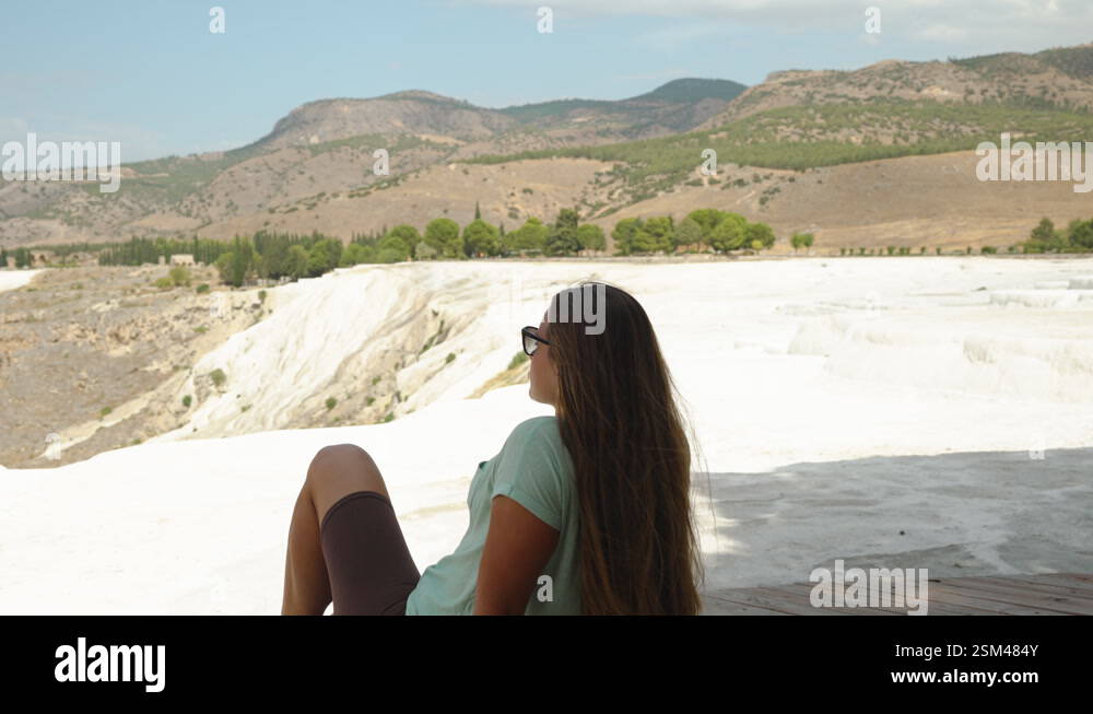 At the top of the White Mountain formed from calcium, a young woman ...