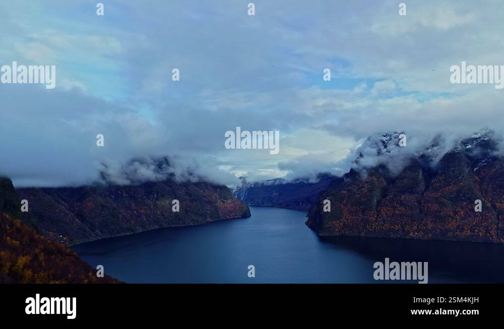 An Idyllic View Of A Calm Lake Surrounded By Misty Mountains On A ...