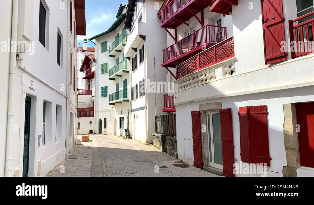 Cobbled street and basque style buildings in the city center of St-Jean ...