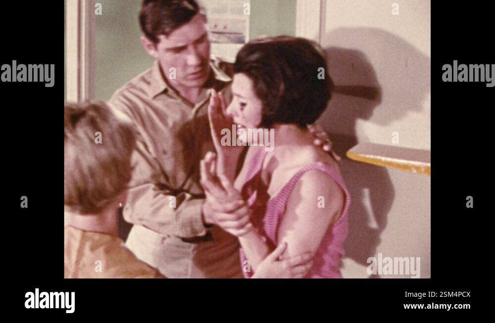 1970s: Man assists woman hit in face by forklift. Car pulls up to stop ...