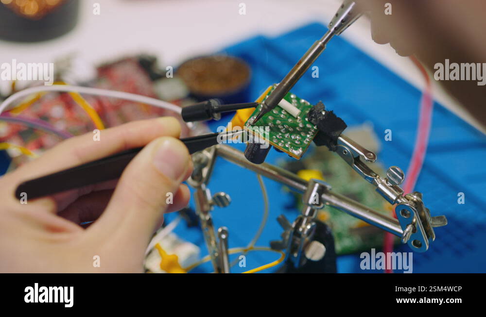 Man is Soldering in a Repair Shop. Concentrated Technician Busy ...