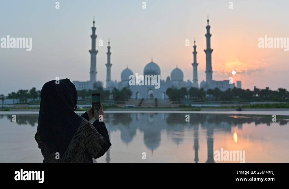 A woman in Hijab takes photos of Syed Zayed Mosque in Abu Dhabi, United ...