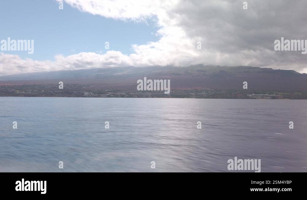 Gimbal wide POV shot from a moving boat of Haleakala volcano from ...