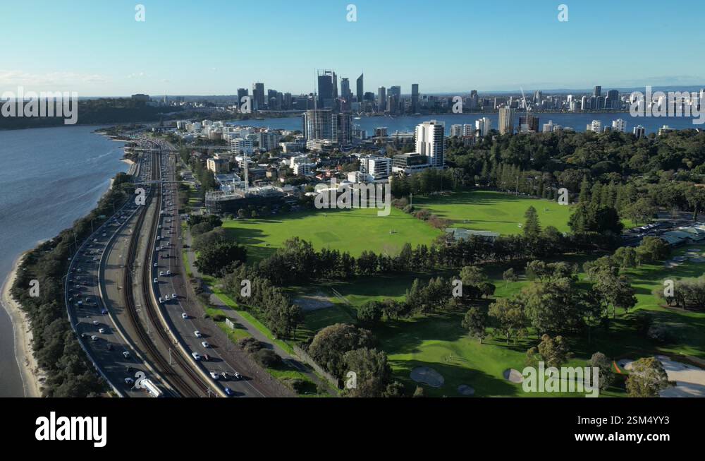Beautiful skyline of Perth Downtown with traffic on highway beside golf ...