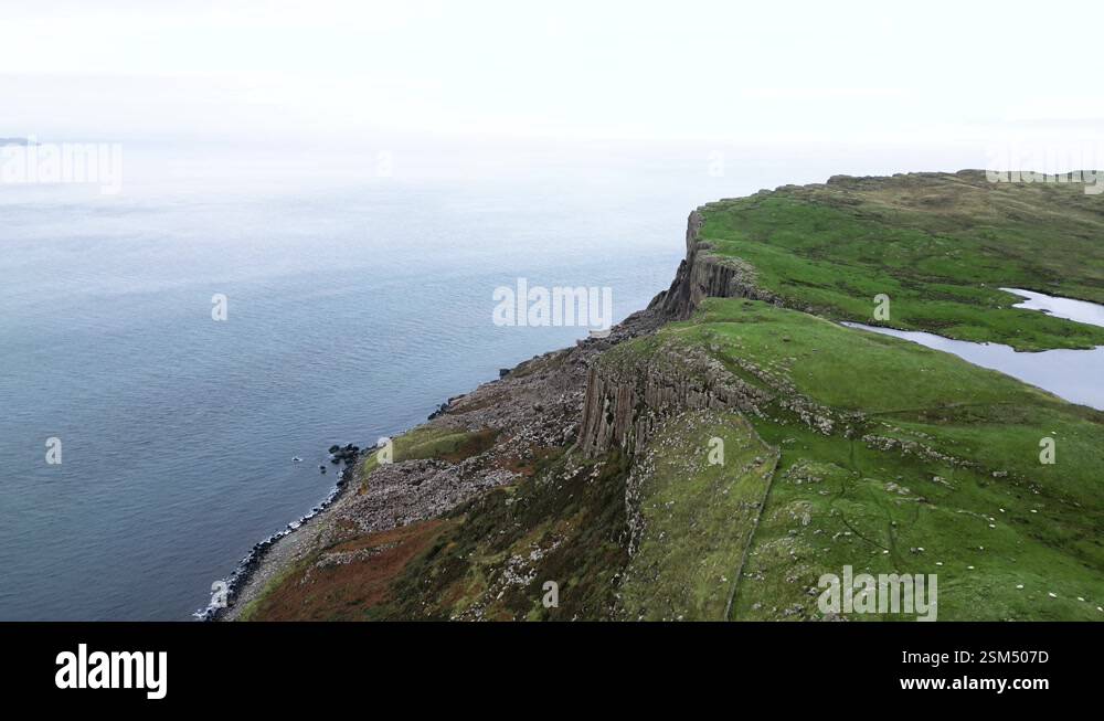 Descending aerial view of the geographically prominent Fair Head in ...